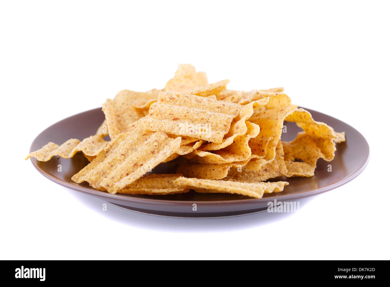 Wheat chips on plate isolated on white background Stock Photo - Alamy