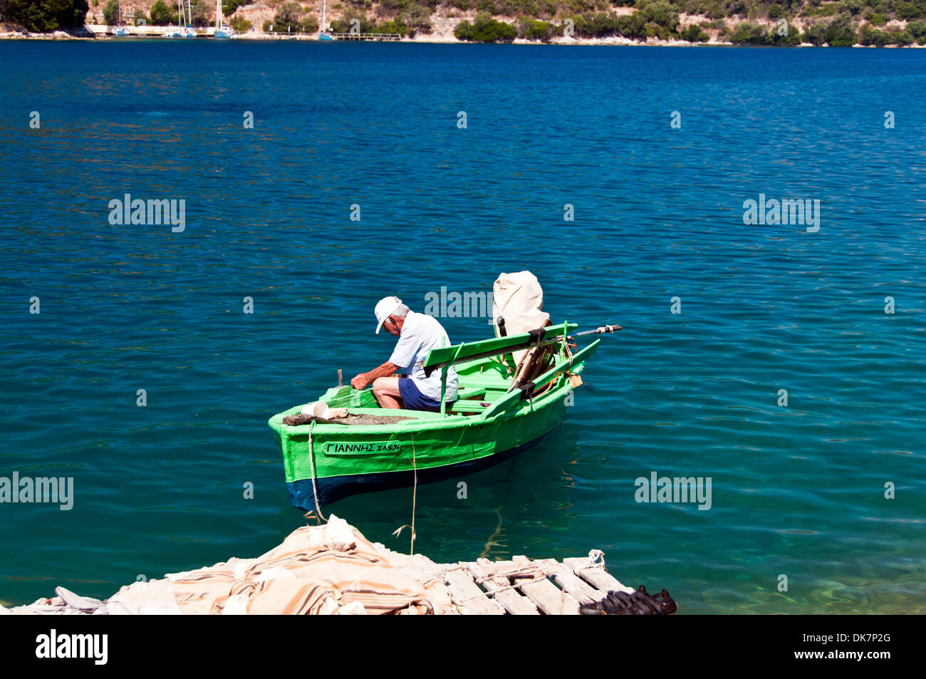 A greek fisherman works on his boat Stock Photo - Alamy