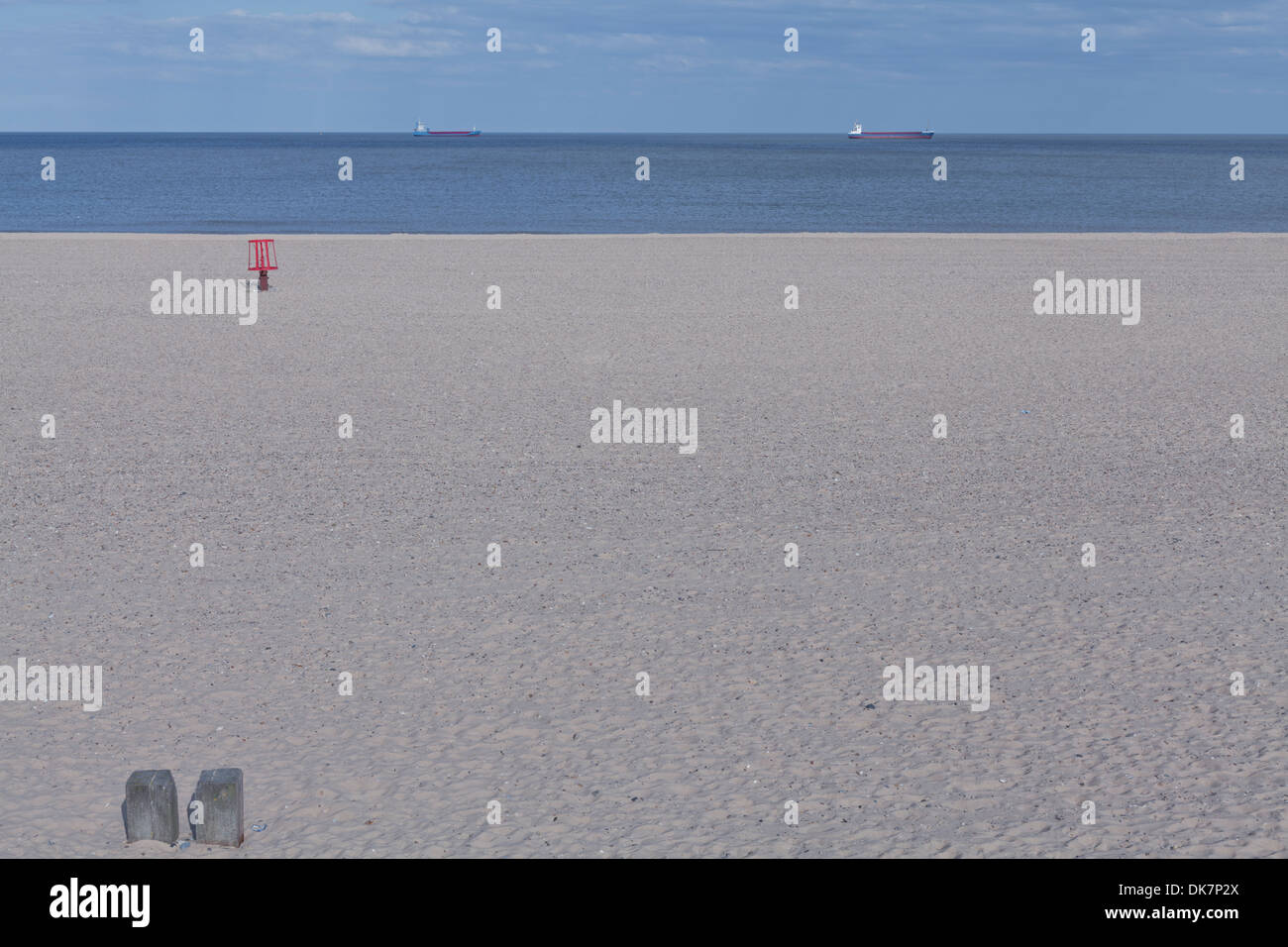 sandy beach with two ships in the distant sea Stock Photo - Alamy