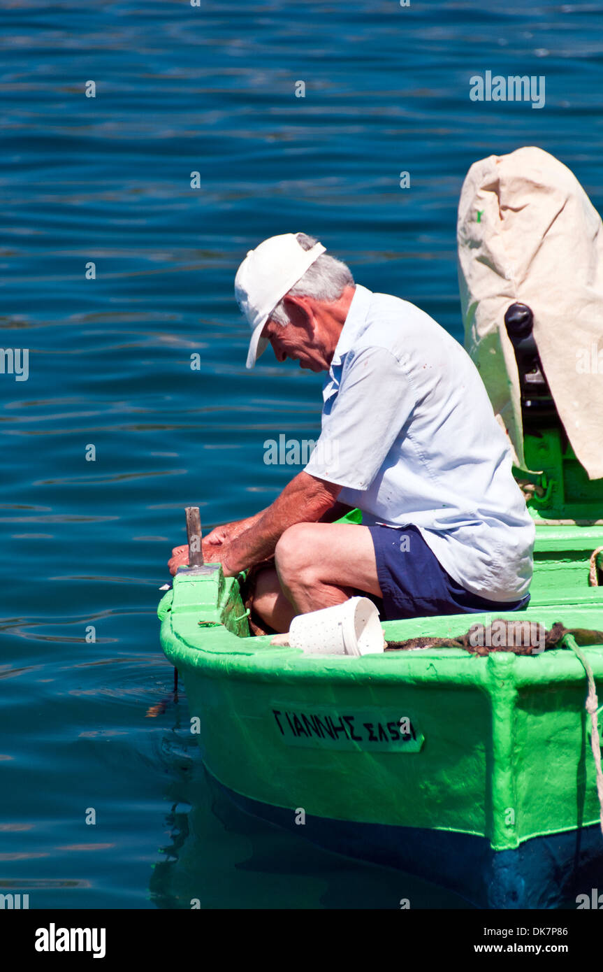 A greek fisherman works on his boat Stock Photo - Alamy