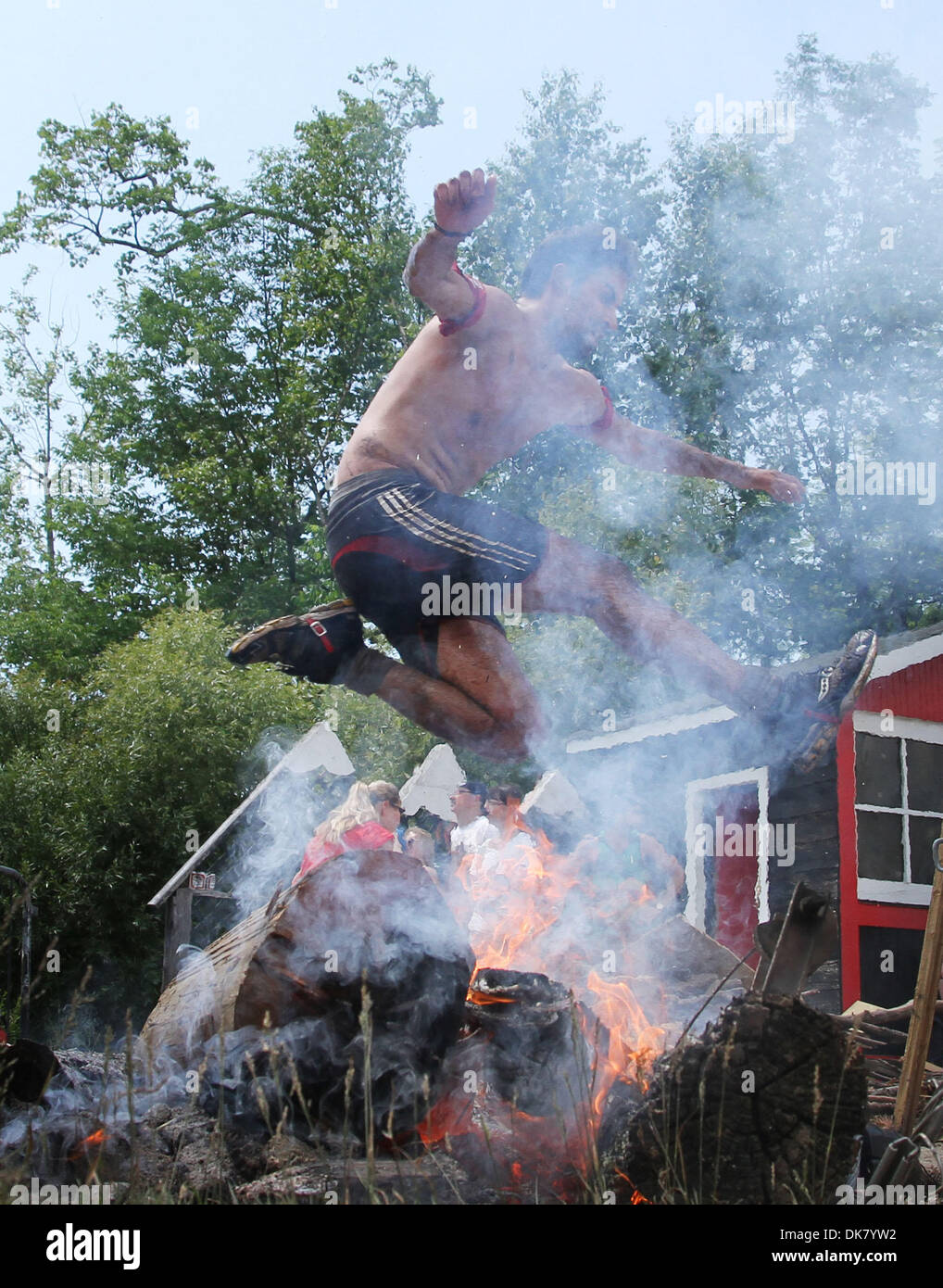 Jul 3, 2011 - Chelsea, Quebec, Canada - A contestant jump over fire ...