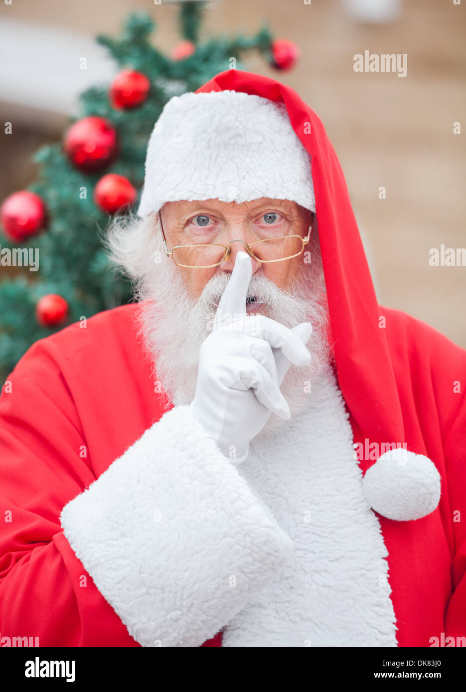 Santa Claus With Finger On Lips Stock Photo - Alamy