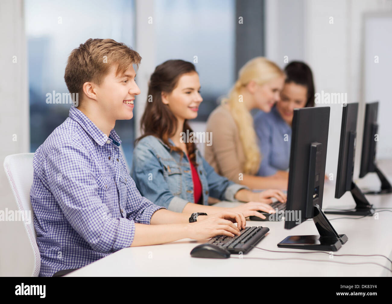 students looking at computer monitor at school Stock Photo - Alamy