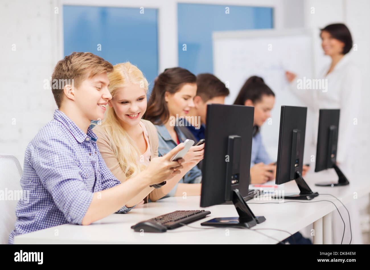students with computer monitor and smartphones Stock Photo - Alamy