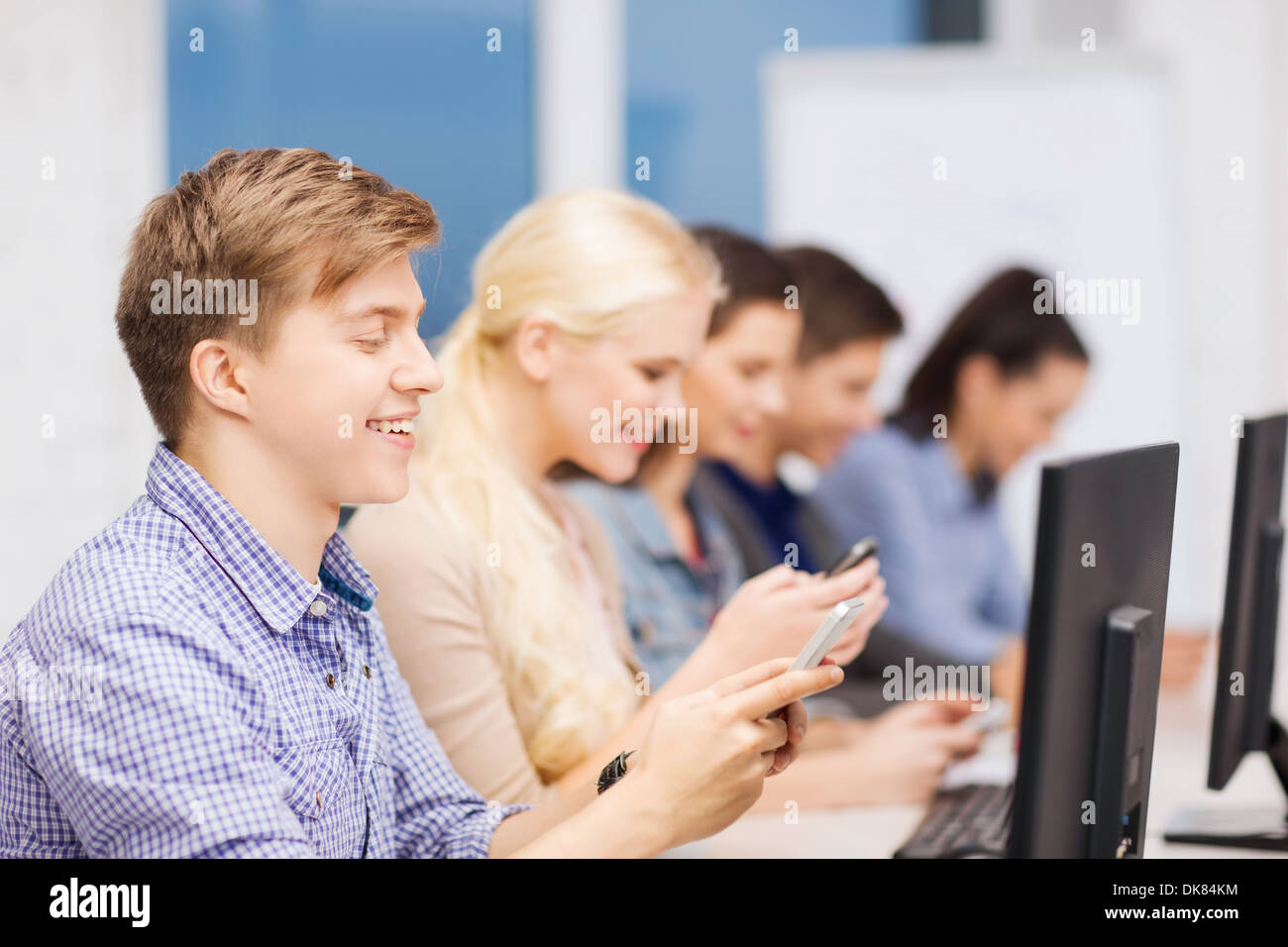 students with computer monitor and smartphones Stock Photo - Alamy