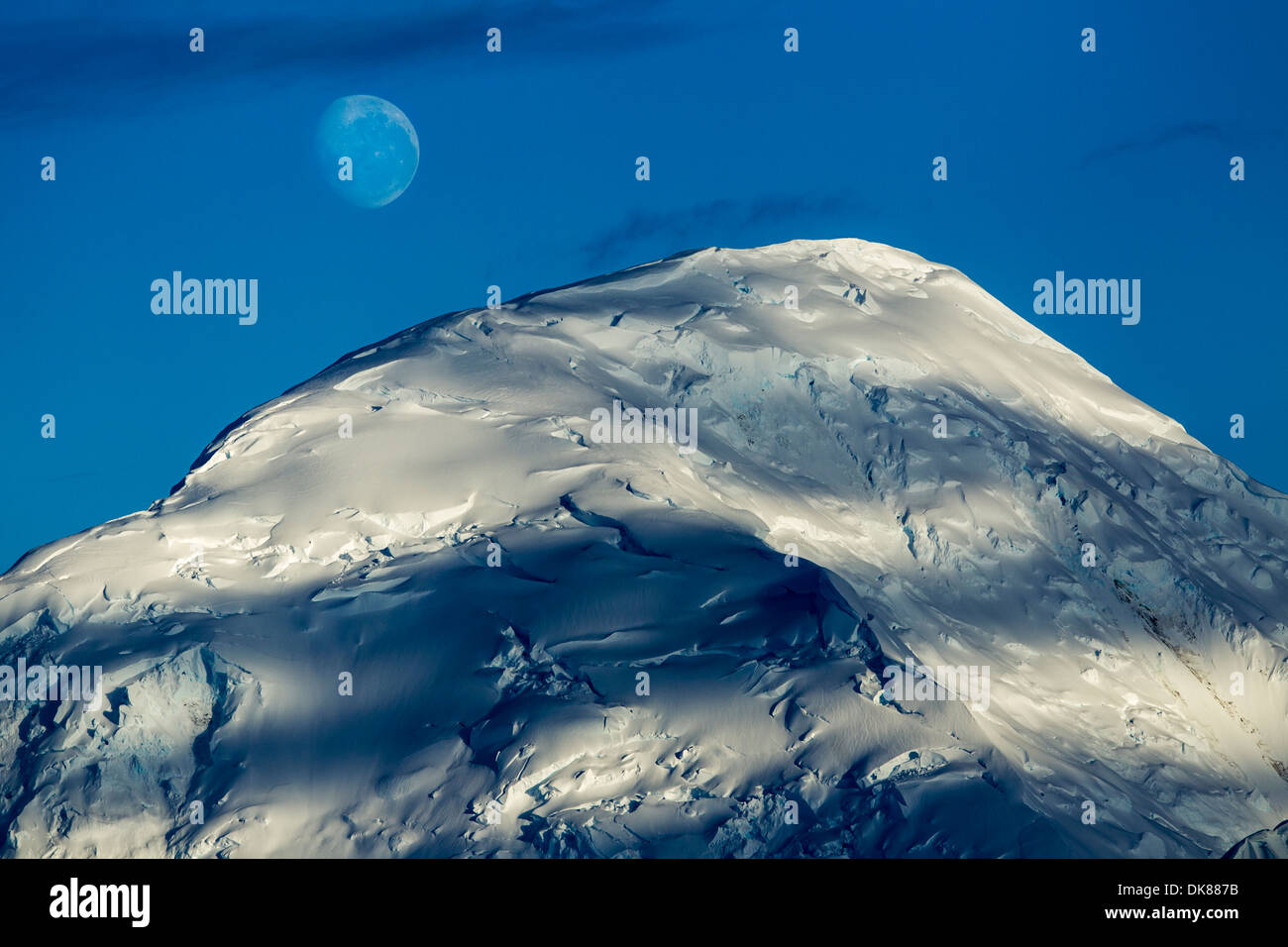 Antarctica, Port Lockroy, Moon sets above glacier-covered summit of ...