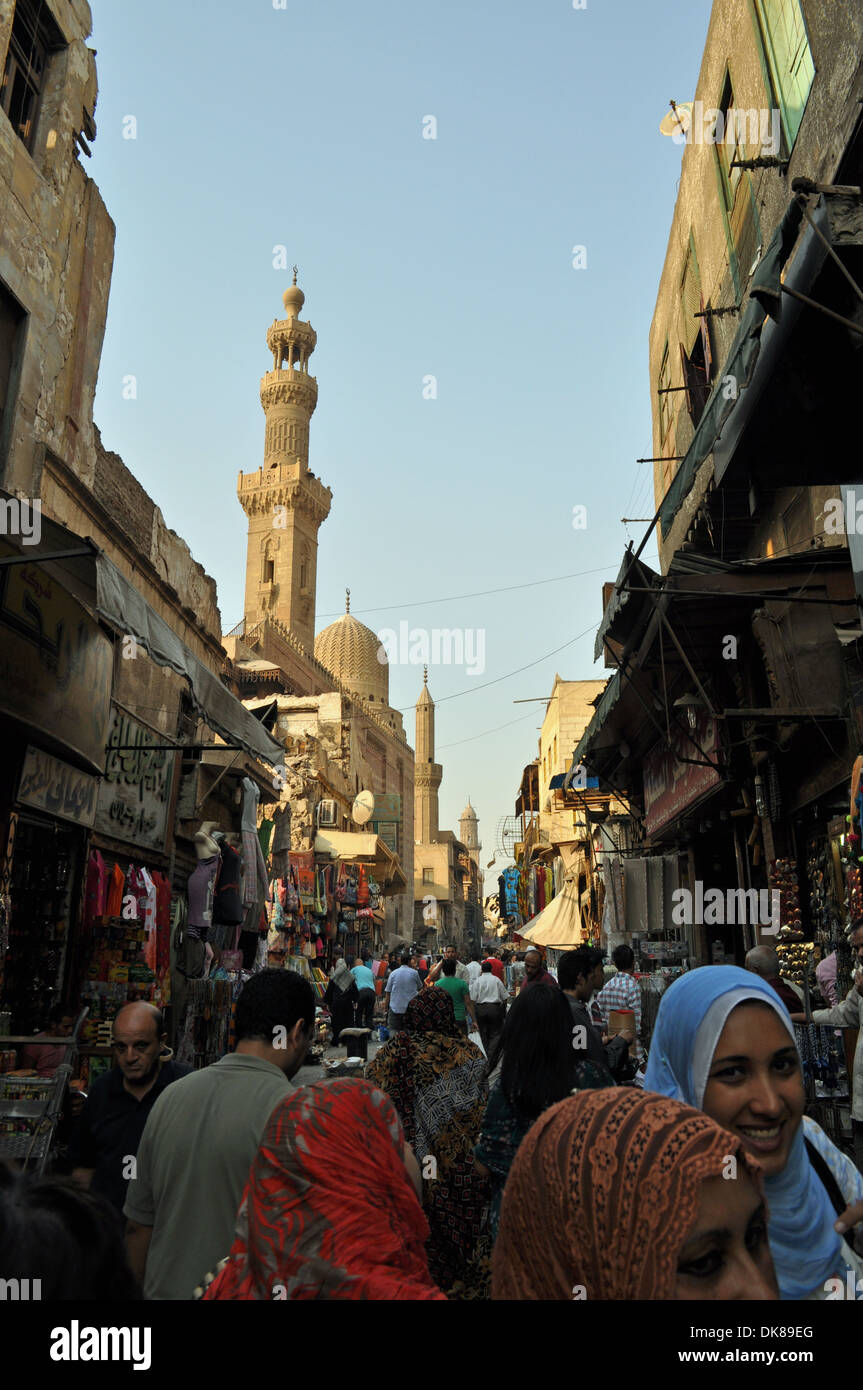 Local women smile while shopping on a narrow crowded street in the ...