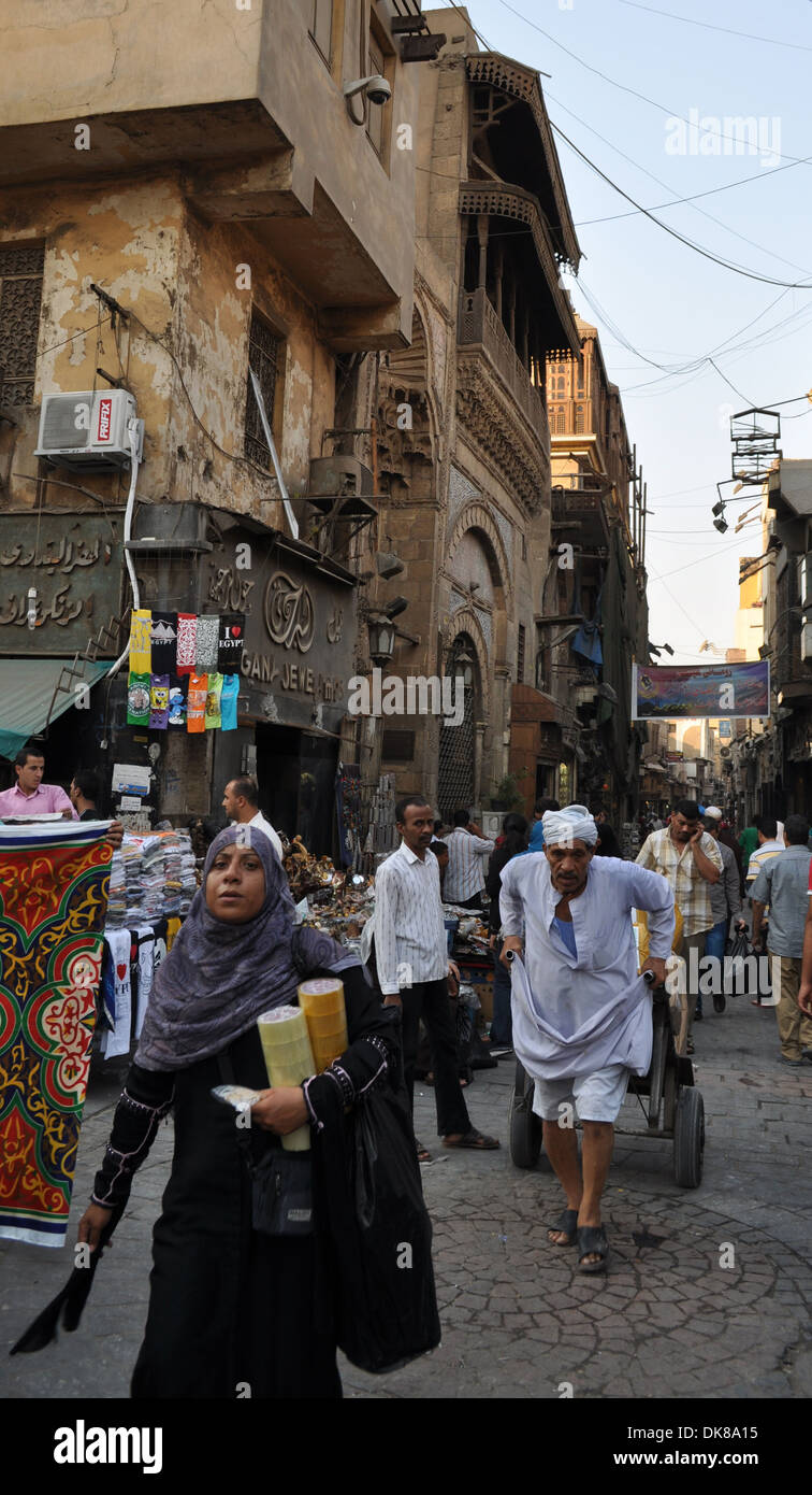 Local people walk down a busy narrow street in the ancient Islamic ...