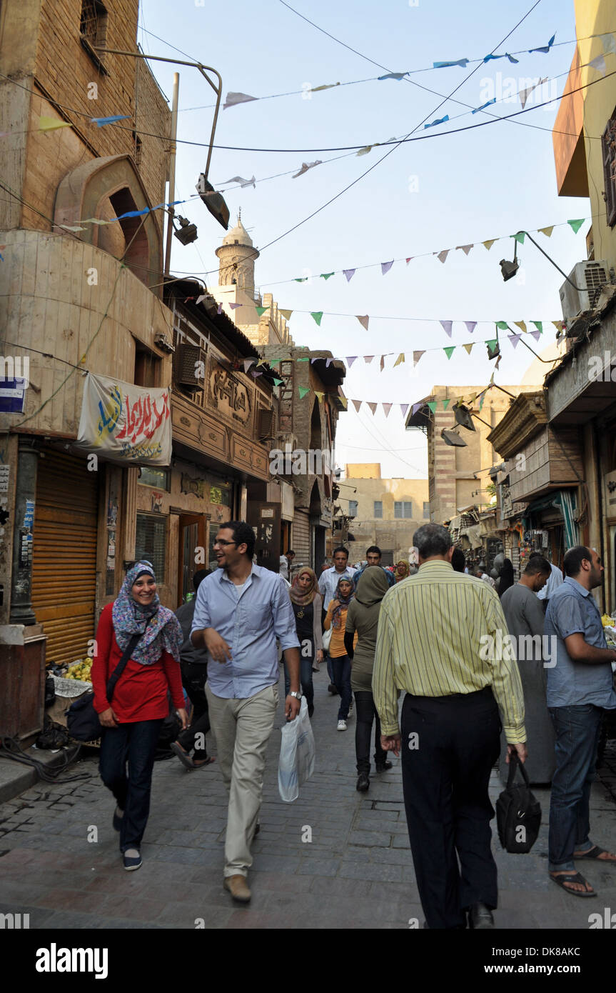 A relaxed young Egyptian couple is among the crowd walking down a ...