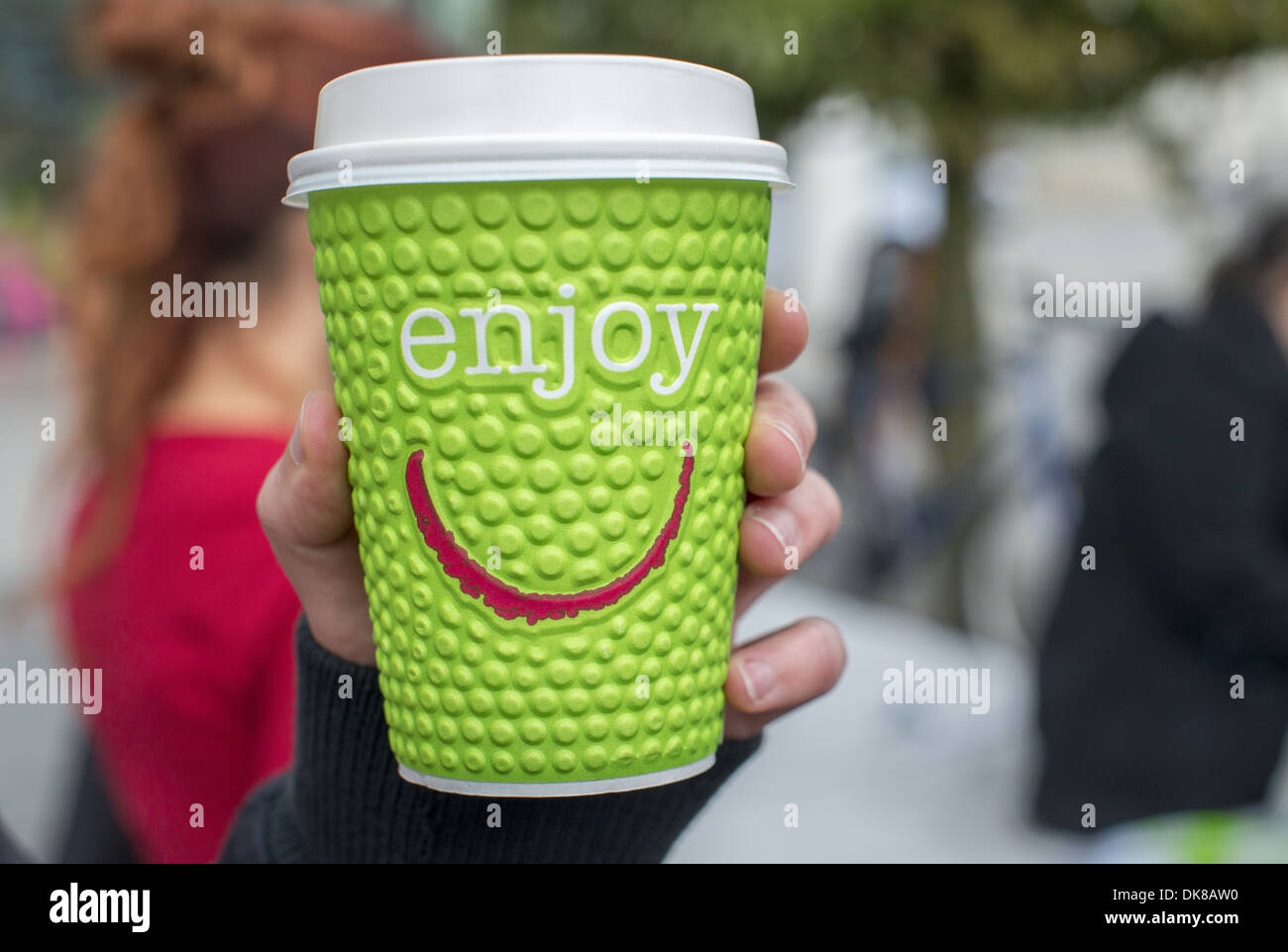 Green happy smiley takeaway coffee cup drink held in hand Stock Photo ...