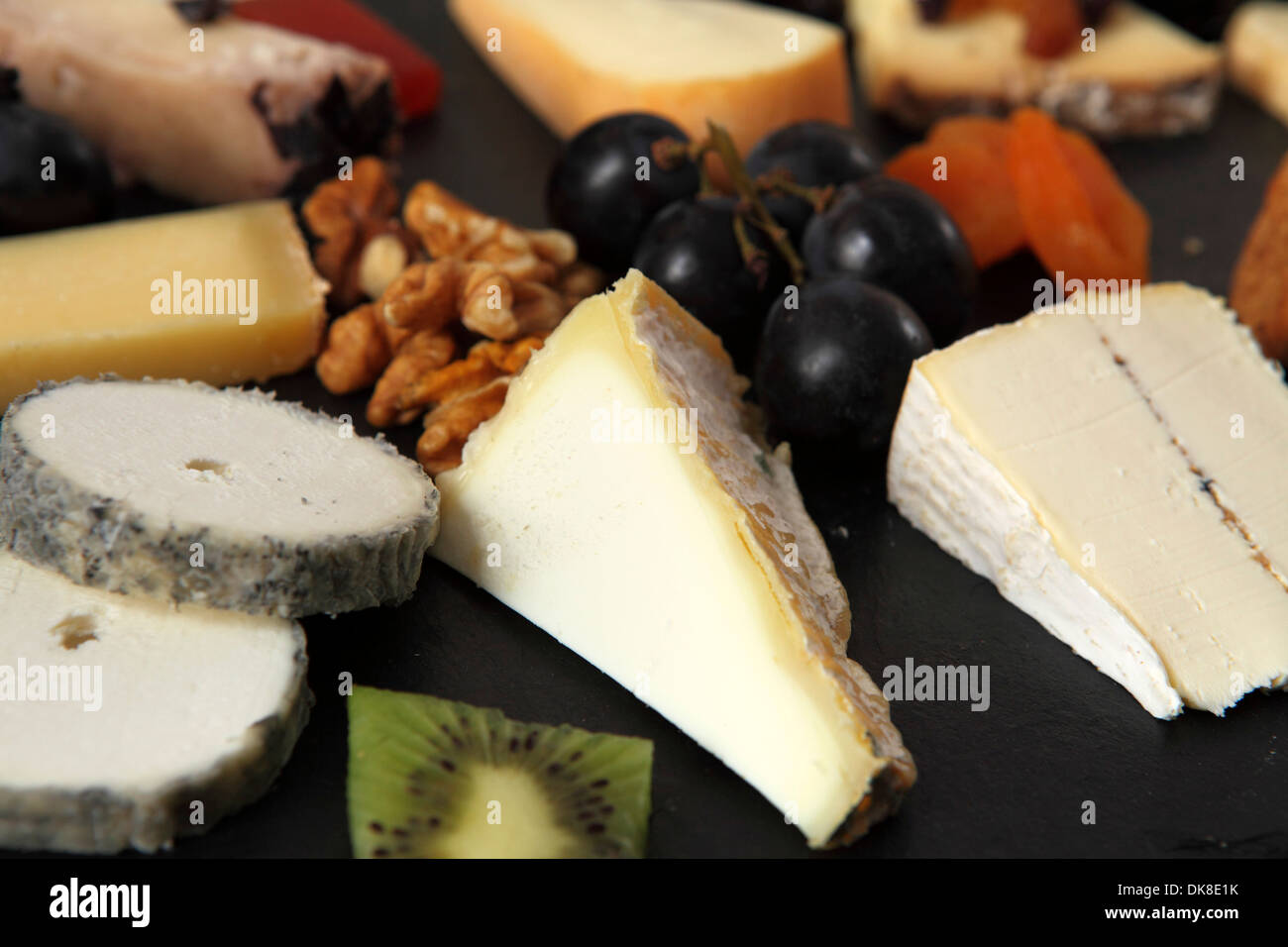A cheese platter with a selection of Continental cheeses. Walnuts ...