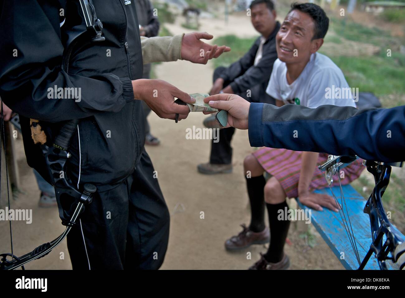 May 6, 2011 - Thimphu, KINGDOM OF BHUTAN - Nima, (only one name), watches players settle bets at ...