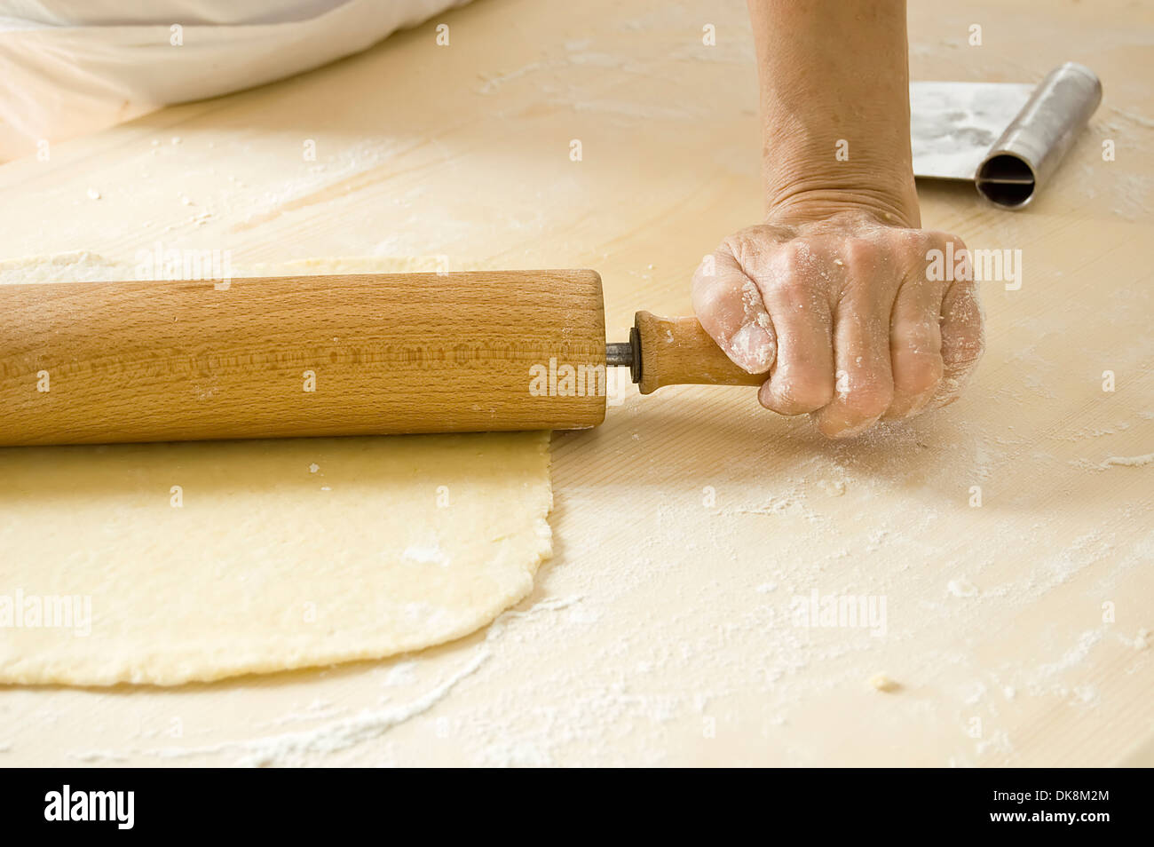 Hand works with rolling pin in kitchen Stock Photo - Alamy