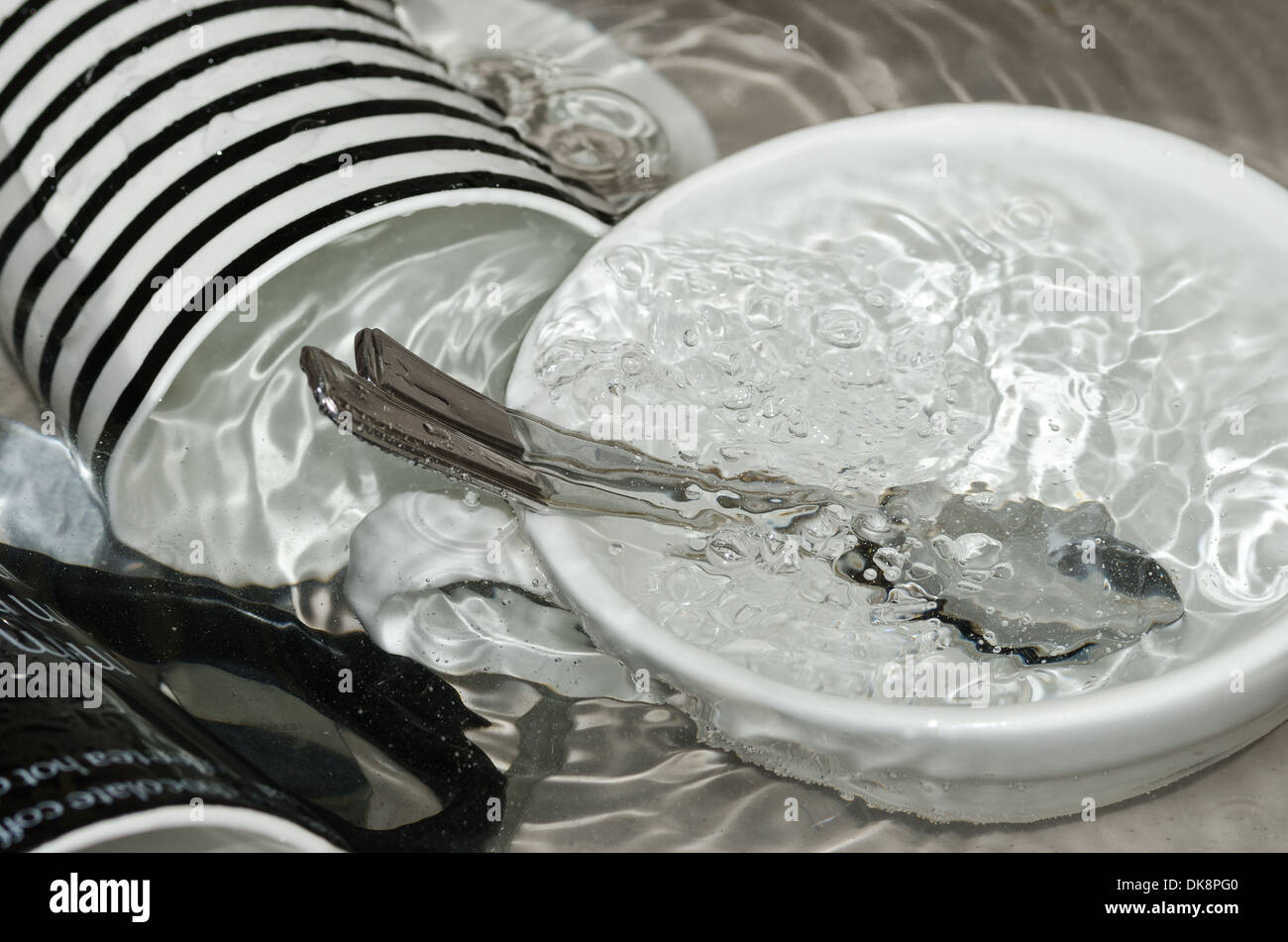 putting off the inevitable washing up cutlery soaking cups mugs in ...