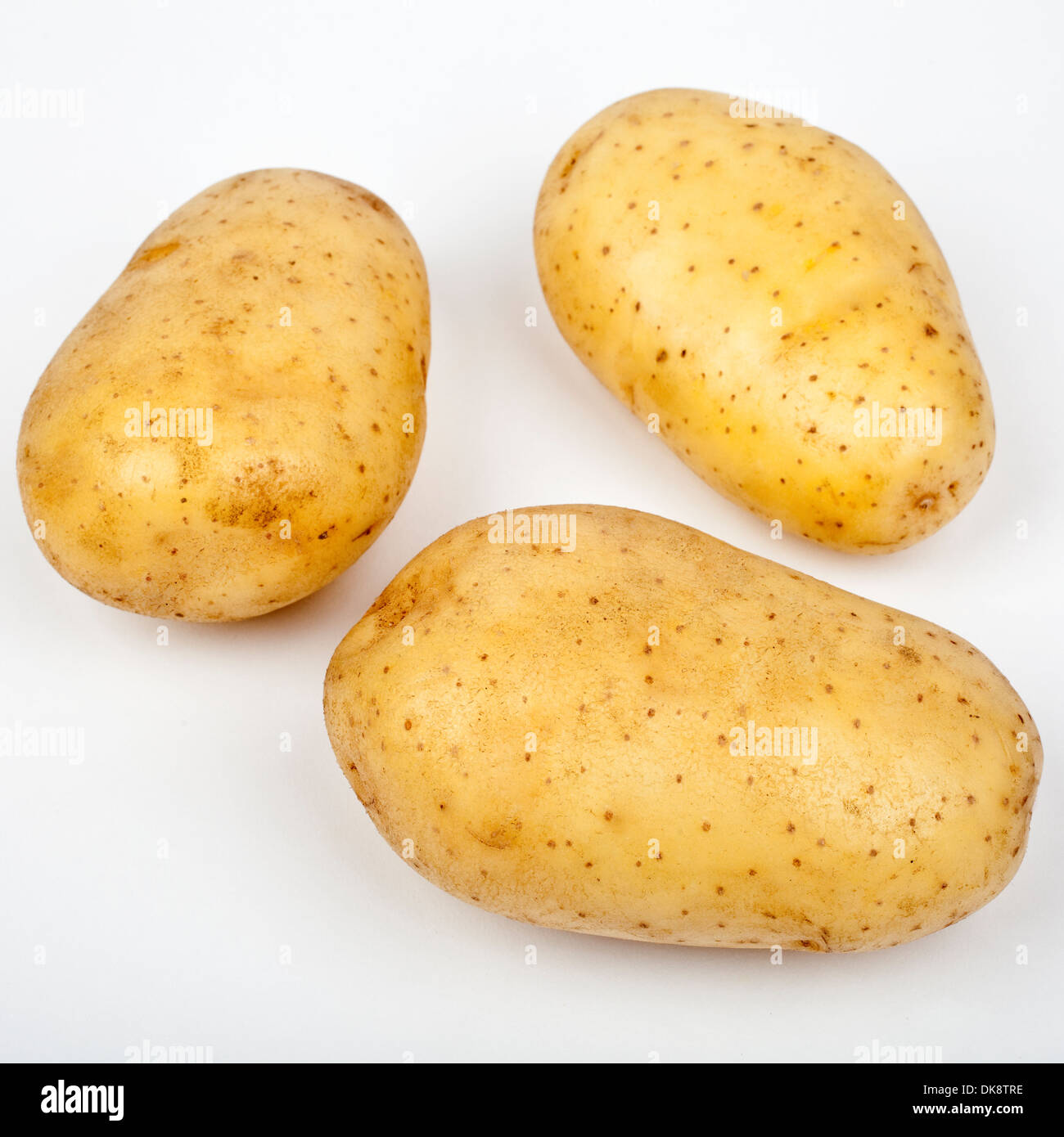 Three potatoes on a white background Stock Photo - Alamy