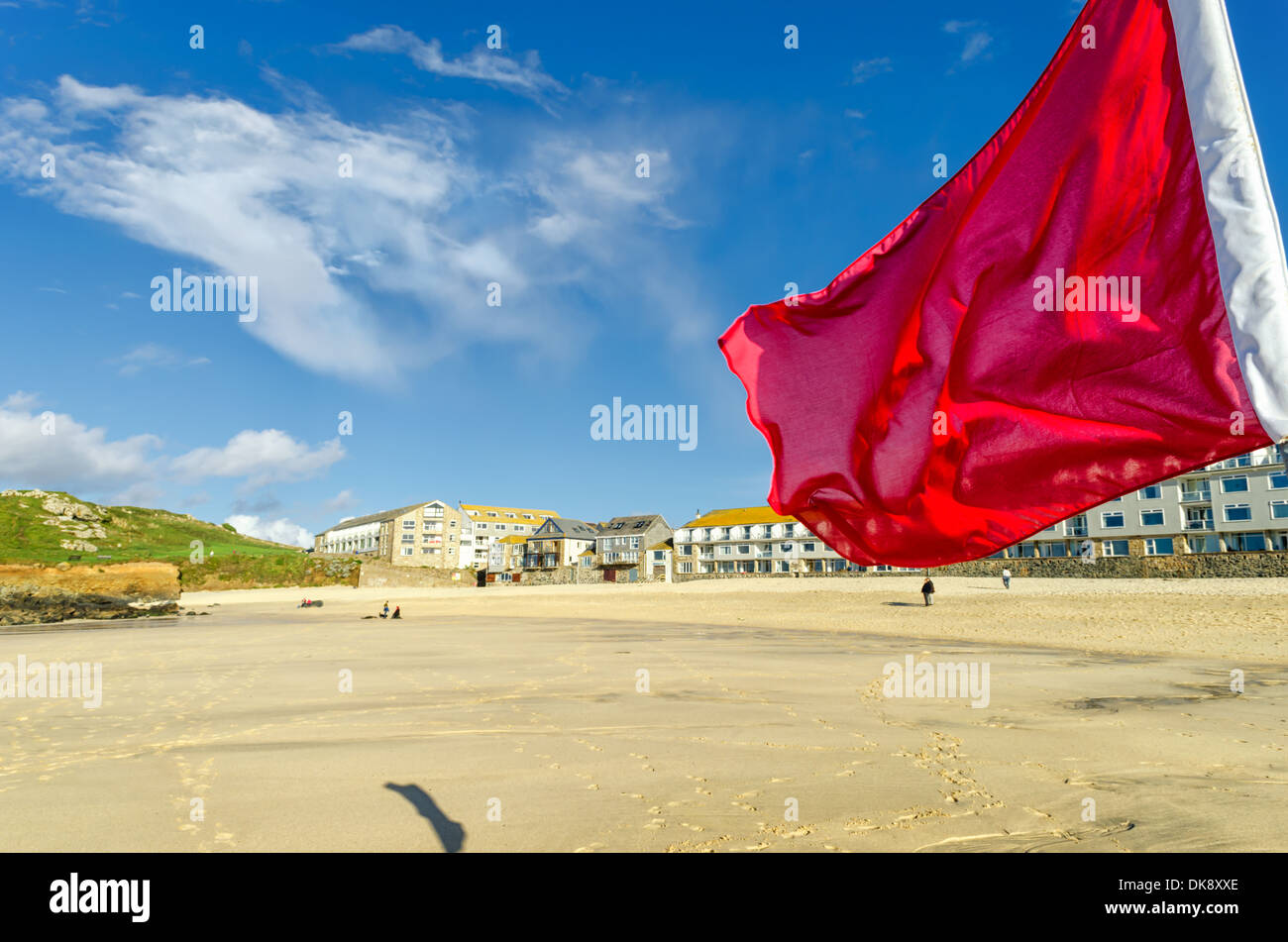 Red lifeguard flag on Porthmeor Beach. St. Ives, Cornwall, England ...