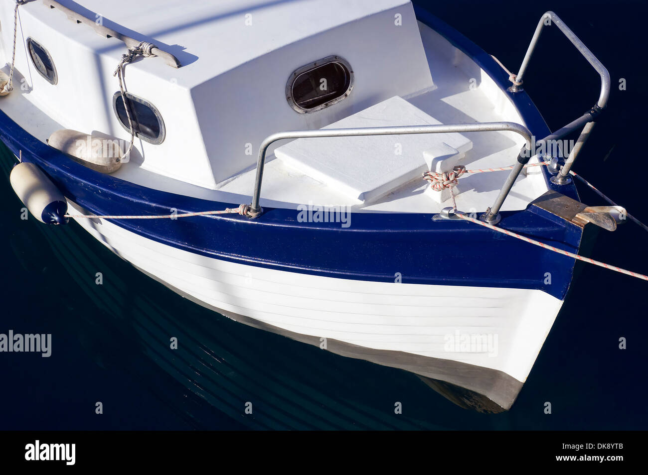 Blue and white little pilot boat with dark background Stock Photo - Alamy