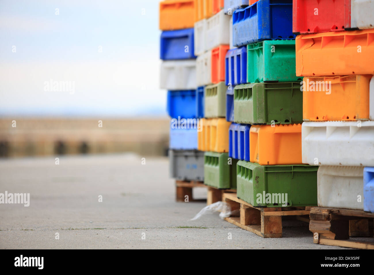 colorful boxes plastic crates. Packing containers piles for fish ...