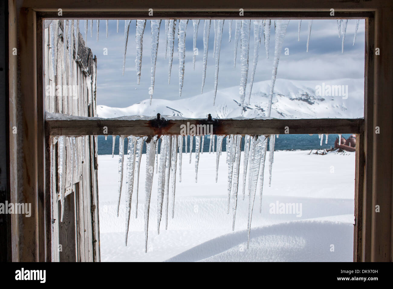 Antarctica, South Shetland Islands, Icicles hang from broken window of ...