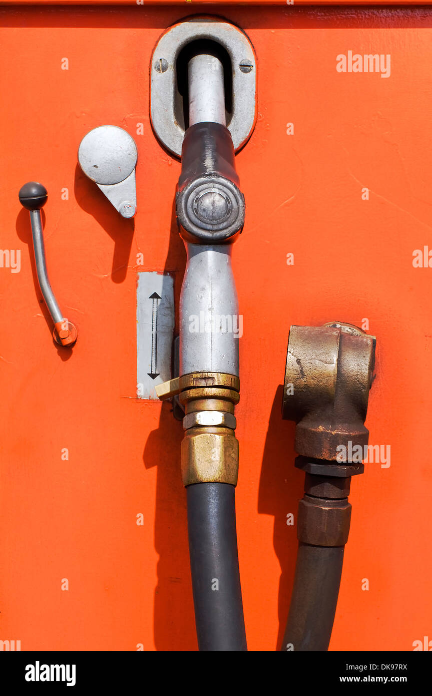 Obsolete orange fuel pump at a gas station Stock Photo - Alamy