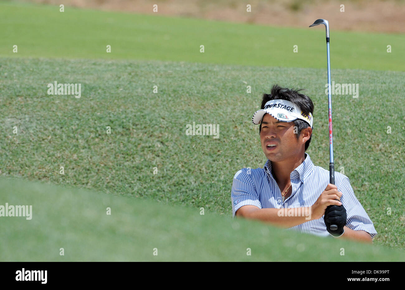 Aug. 14, 2011 - Johns Creek, GEORGIA, U.S. - Golfer Yuta Ikeda of Japan follows his shot out of ...