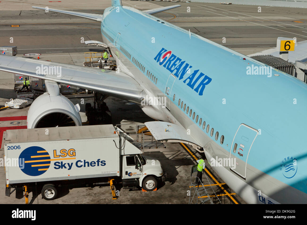 Workers loading food into Korean Air Boeing 777-200 plane - San ...