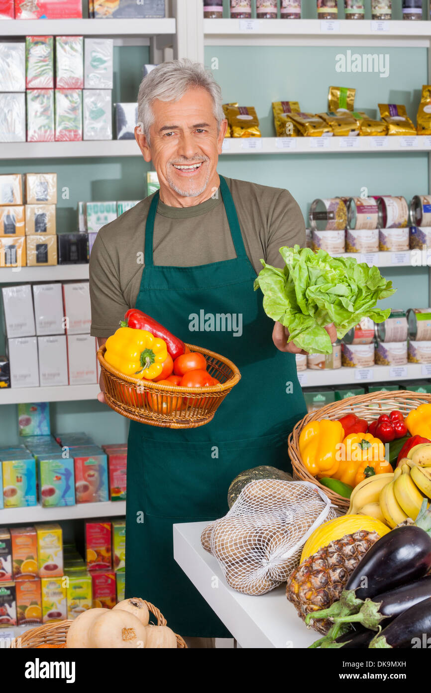 Senior Salesman Selling Vegetables In Supermarket Stock Photo - Alamy
