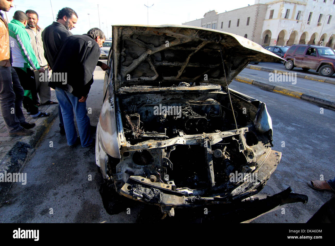 Benghazi, Libya. 04th Dec, 2013. People look at the damaged police car ...