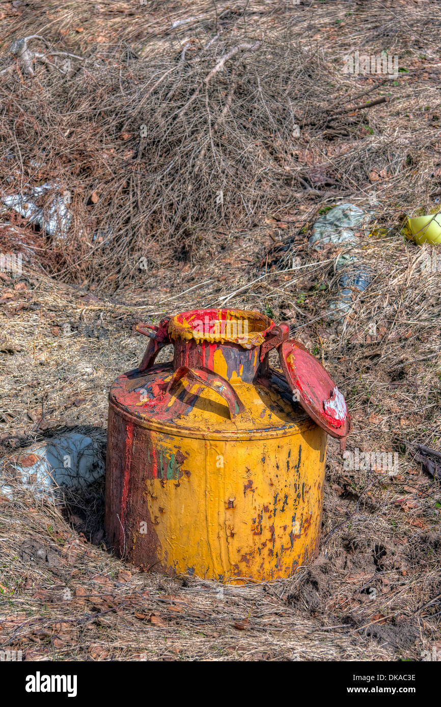 Old forgotten soviet time milk churn covered with paint on the ground ...