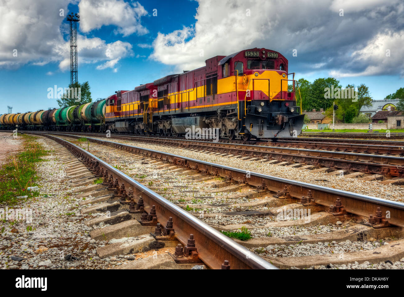 Long freight train on slide rails at cloudy day Stock Photo - Alamy