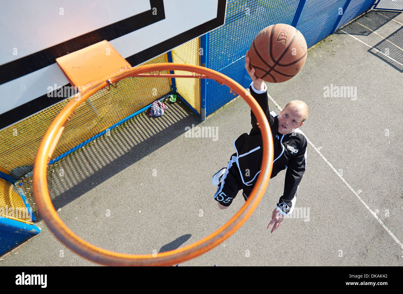 A basketball player performs a lay up seen from above the basket Stock ...