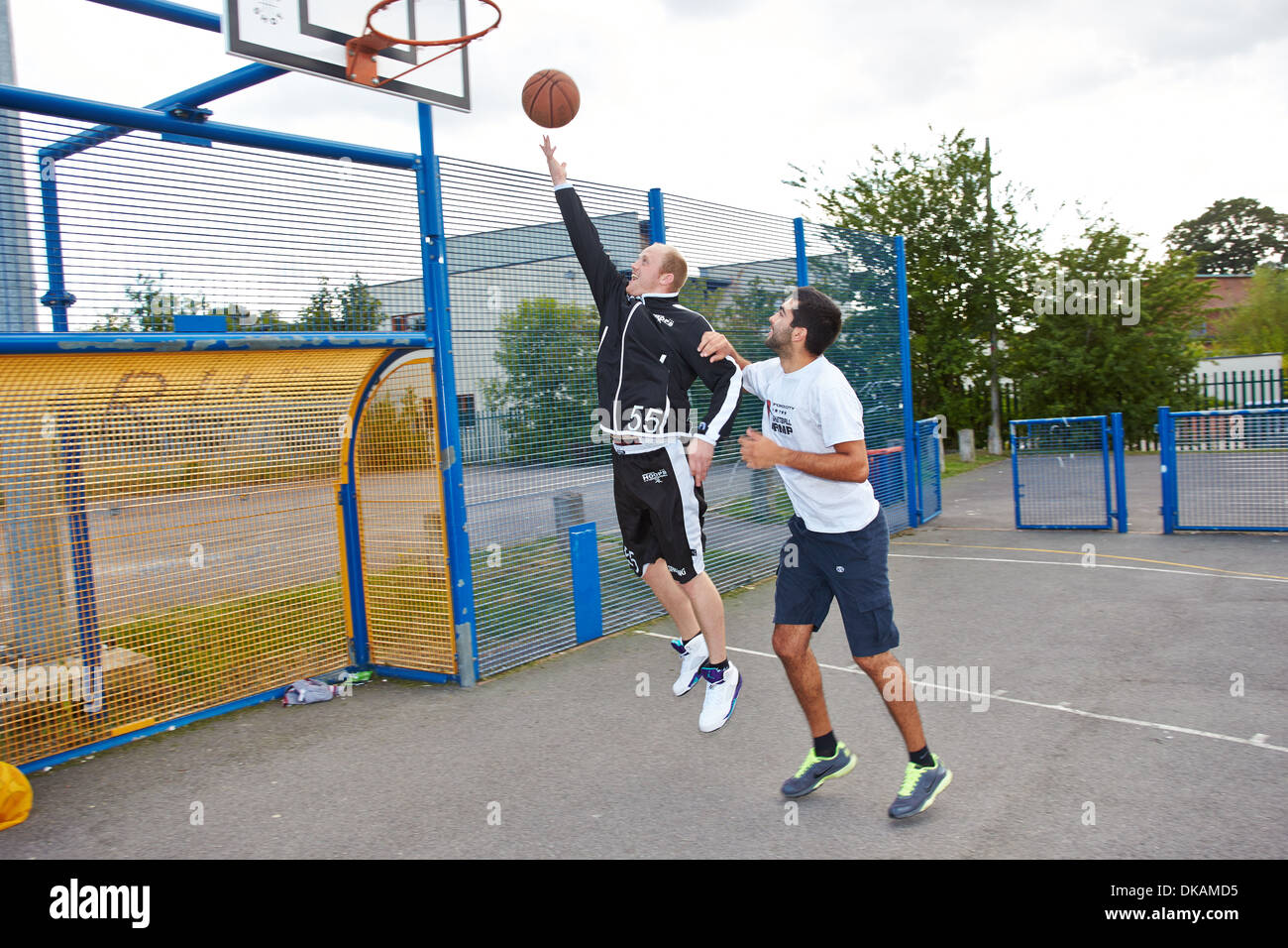 Two basketball players playing against each other outdoors Stock Photo ...