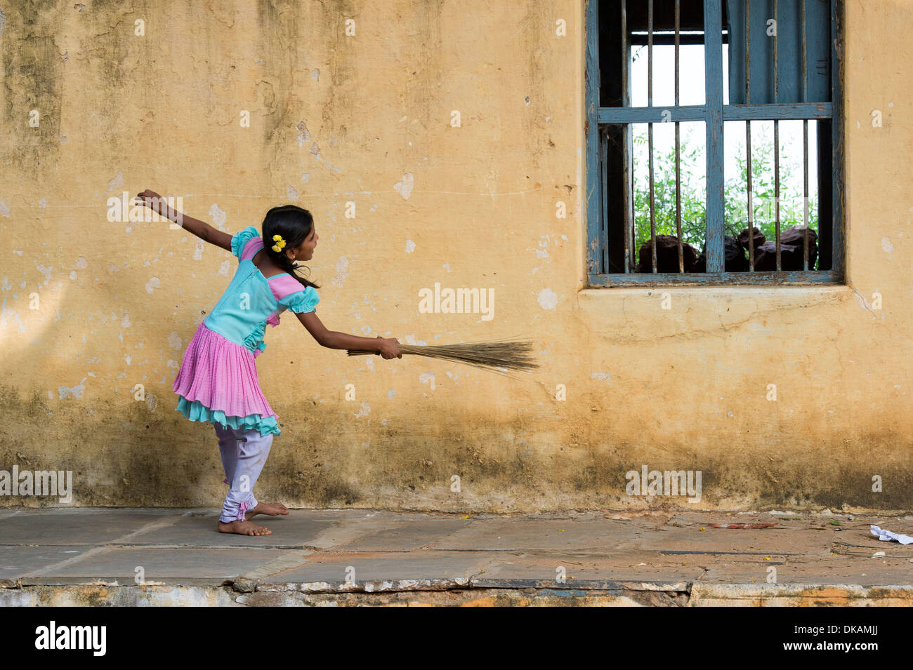 Young Indian girl sweeping in a rural indian village. Andhra Pradesh ...