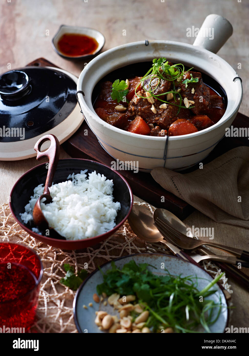 Table with Thai hot pot served with steamed rice Stock Photo - Alamy
