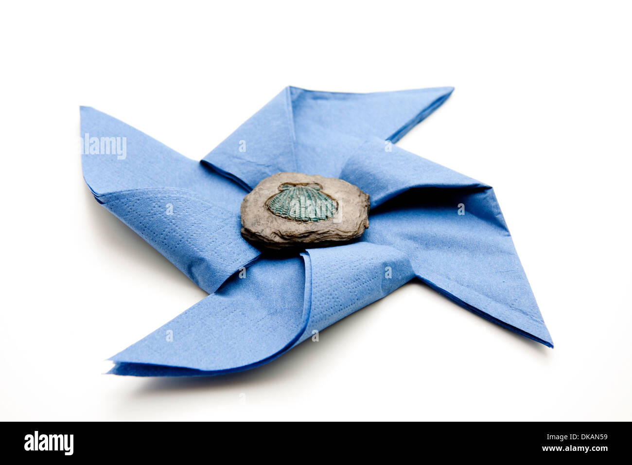 Blue table napkin with stone Stock Photo - Alamy