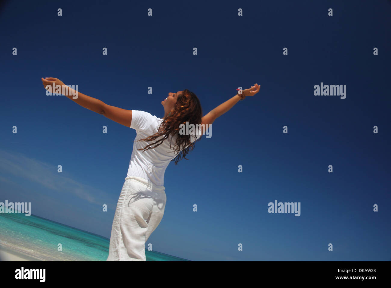 Young woman with arms outstretched on beach, Paradise Island, Nassau ...