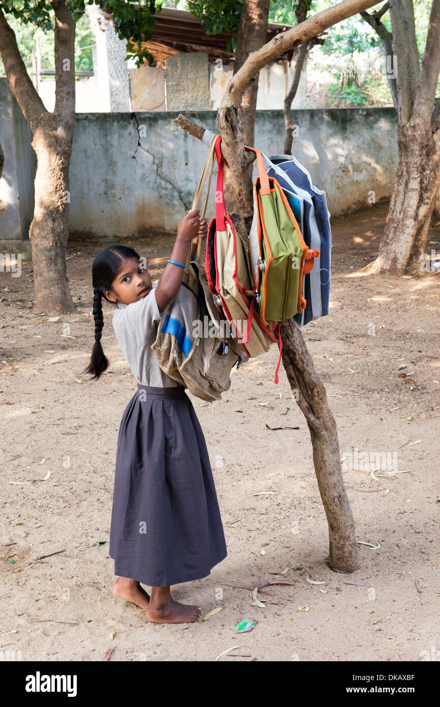 Rural Indian village school girl getting her bag hanging on a tree in ...