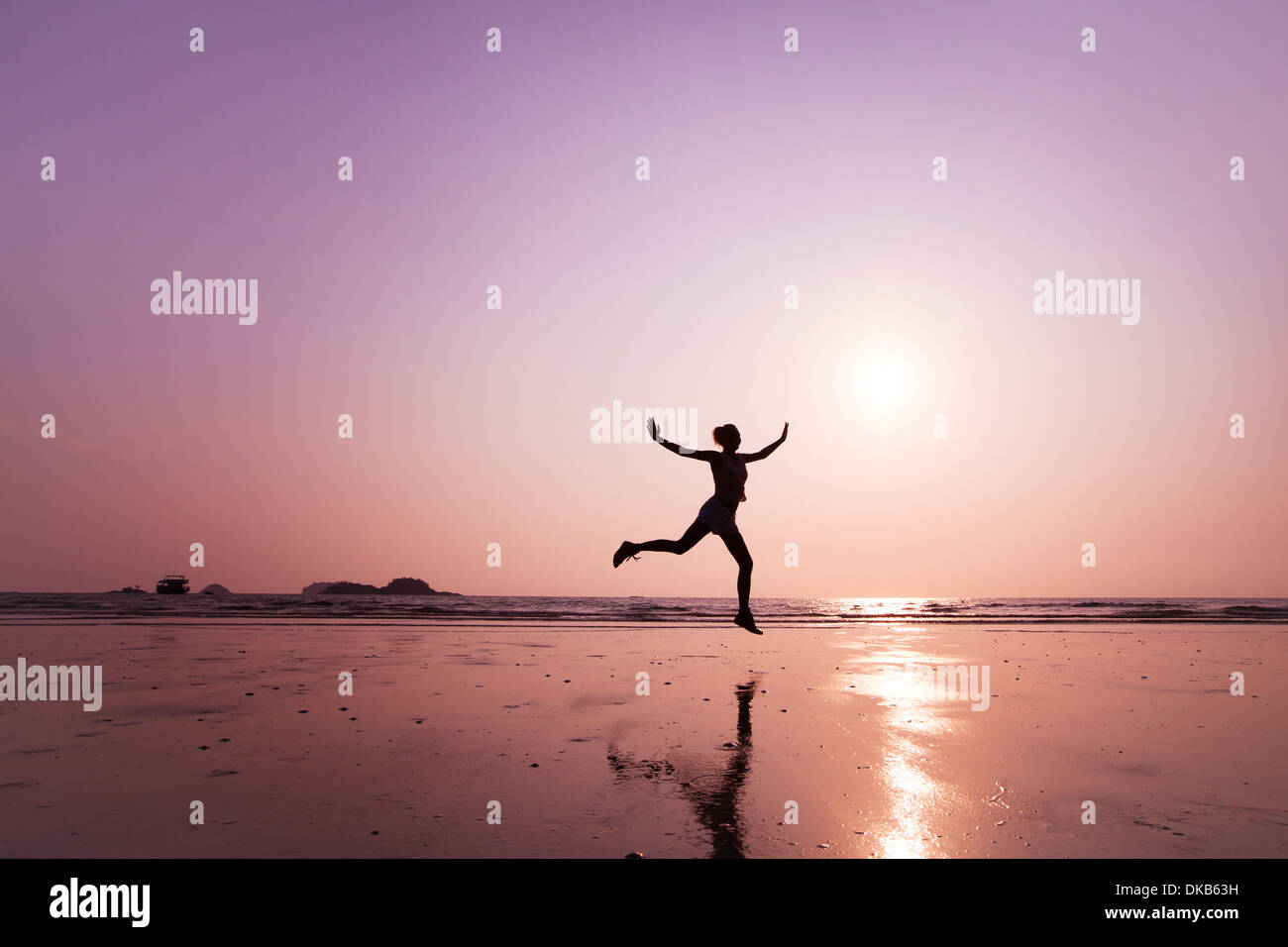 Woman jumping beach hi-res stock photography and images - Alamy