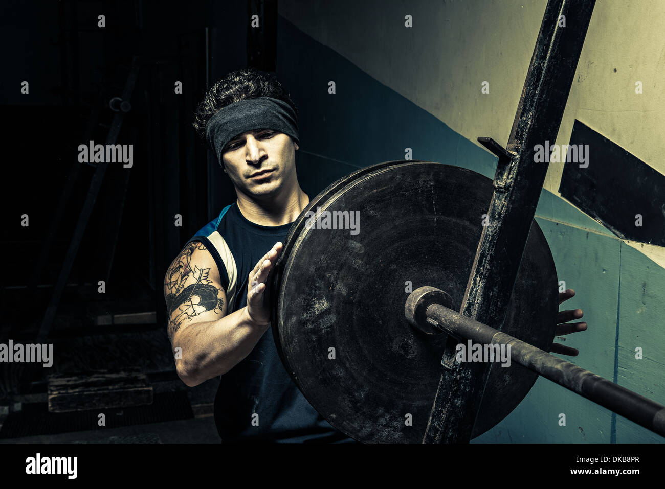 Weightlifter in dark gym Stock Photo - Alamy