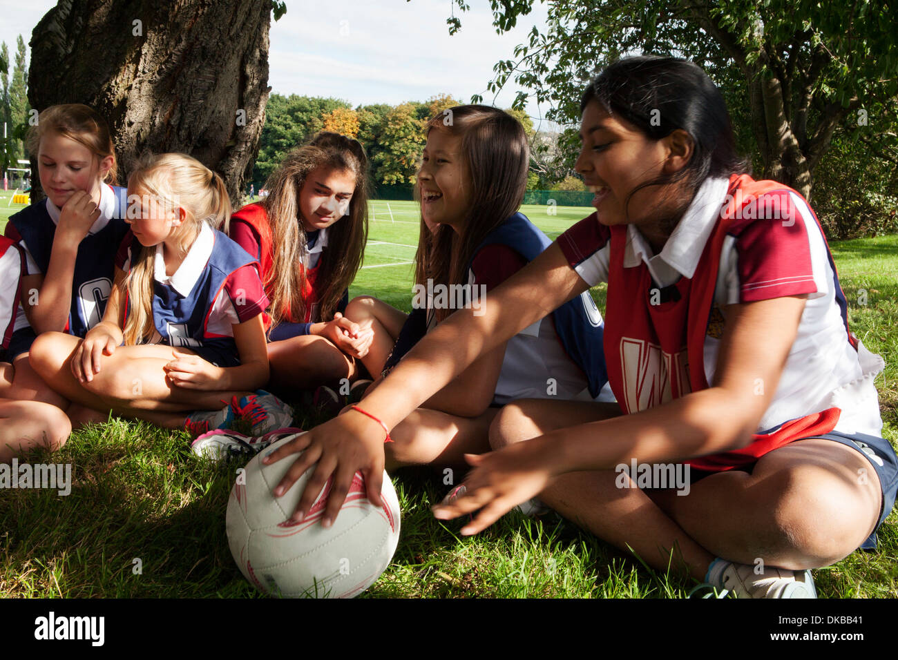 Teenage schoolgirl netball team relaxing in break Stock Photo - Alamy