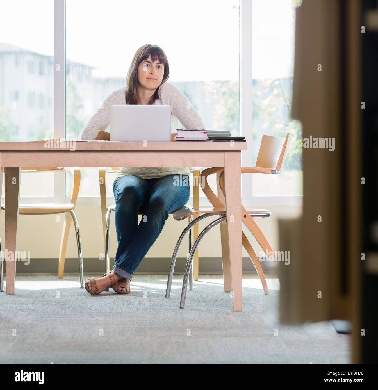 Portrait Of Student Sitting In Library Stock Photo - Alamy