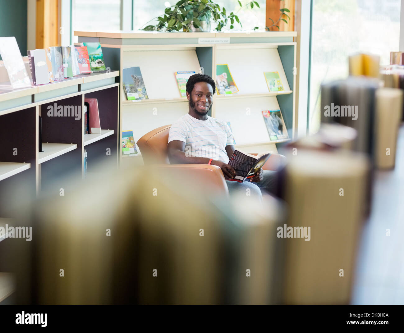 Student Reading Book In Library Stock Photo - Alamy