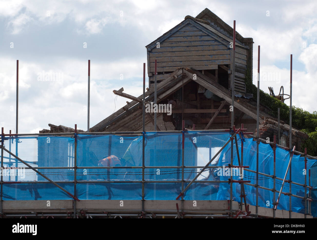 The wooden top of old Victorian mill building as it's being demolished ...