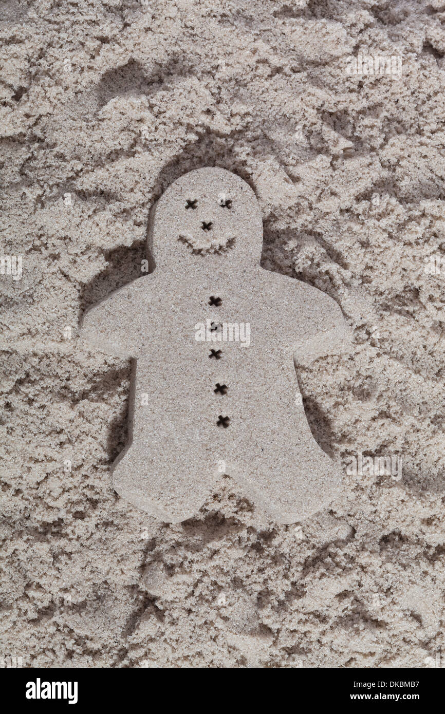 Gingerbread man cookie made from sand in the sand on the beach Stock ...