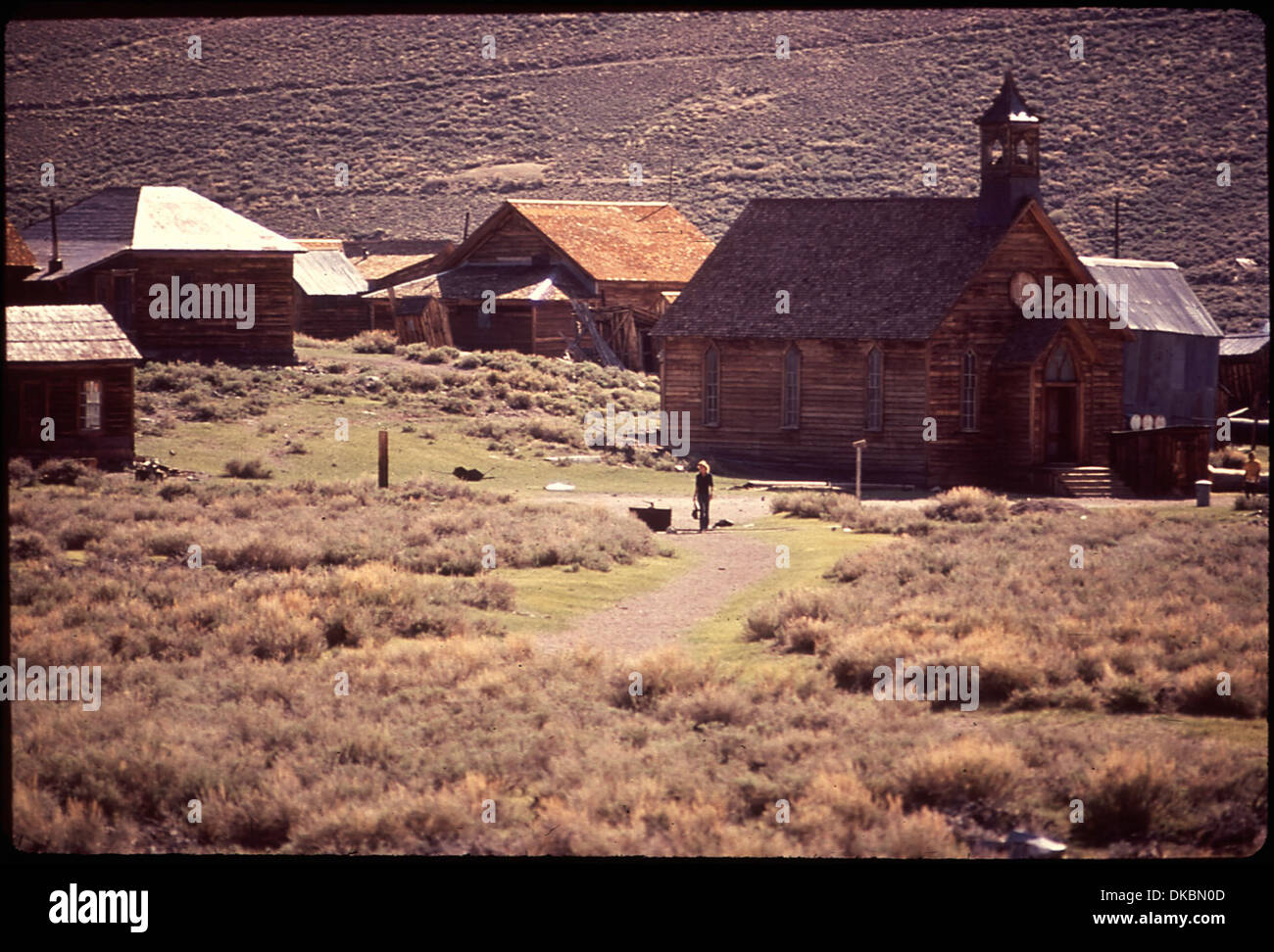 This image depicts a deserted ghost town, likely from the American West ...