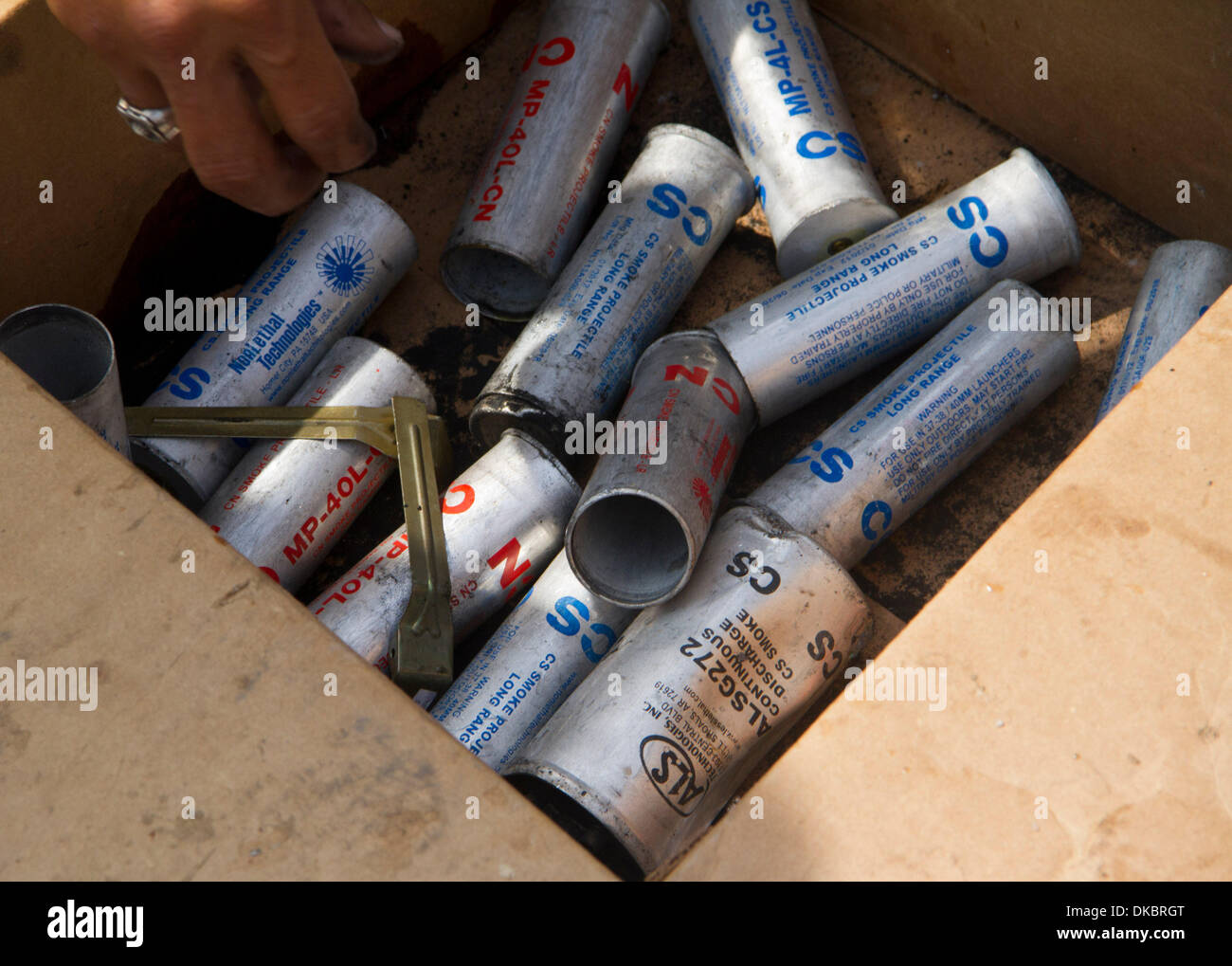 Thai anti-government protesters show collected tear gas canisters and ...