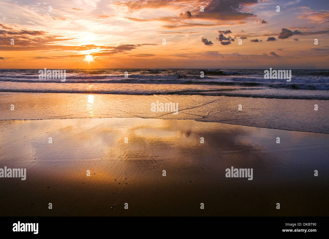 Colorful cloudy sunset at the beach with reflection - horizontal Stock ...