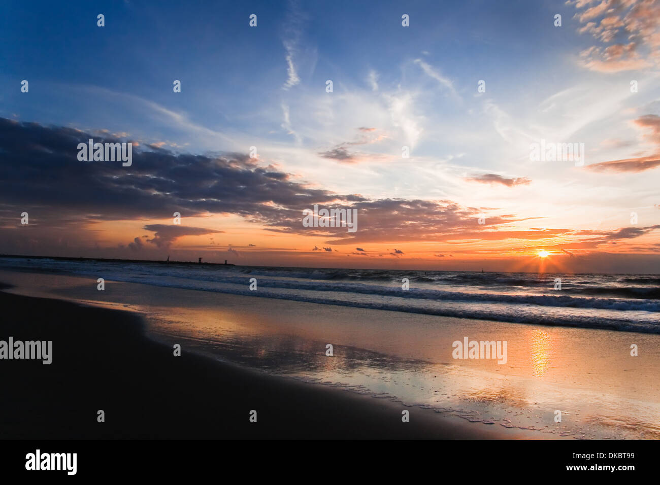 Colorful cloudy sunset at the beach with reflection - horizontal Stock ...