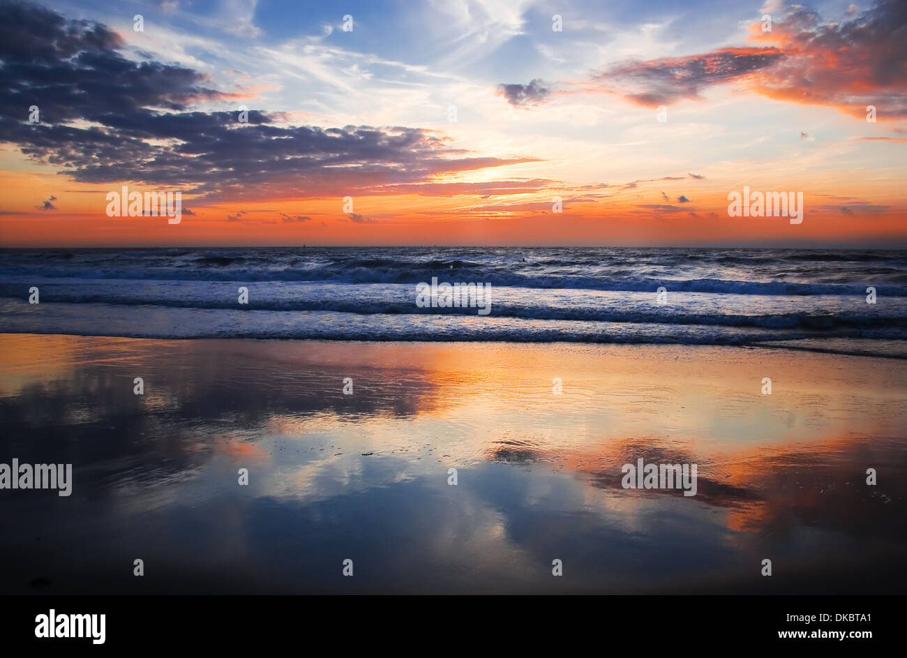 Colorful cloudy sunset at the beach with reflection - horizontal Stock ...