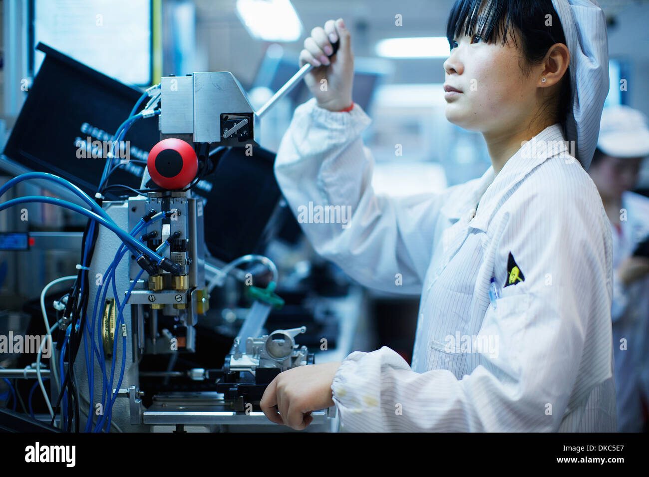 Worker at small parts manufacturing factory in China Stock Photo - Alamy